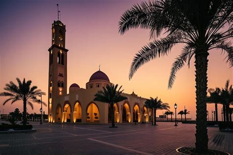 domed mosque lake reflection lush greenery palm trees premium ai