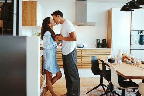 Loving Couple Kissing In Their Kitchen Stock Image Image Of Eyes