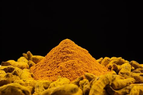 Turmeric Powder And Dried Turmeric Root On A Black Background Premium