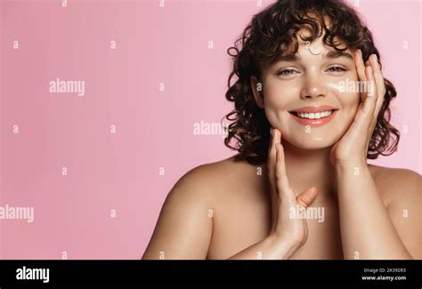 Beautiful Natural Girl Smiling Rubbing Her Face With Facial Cleanser