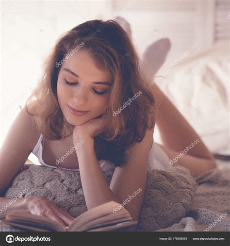 Beautiful Blond Woman Reading Book In The Bed Relaxing Concept Stock