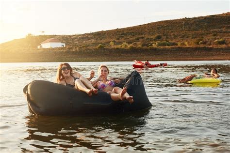 Portrait Float And Friends In Lake On Holiday To Chill Smile Or Enjoy