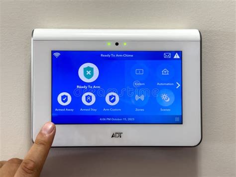 A Person Using An Adt Security Touch Screen Panel Control On A Wall Editorial Image Image Of