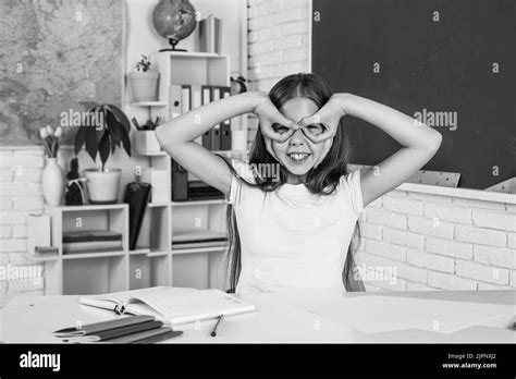 Smiling Teen Girl Making Faces In School Classroom Having Fun Stock
