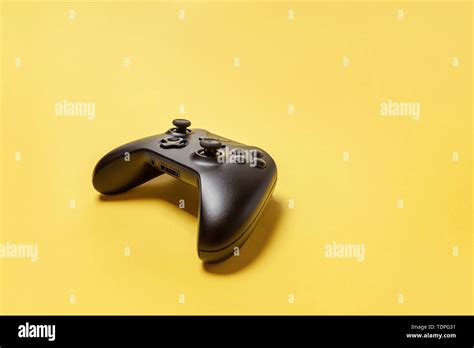 Black Joystick Gamepad Game Console On Yellow Colourful Trendy Modern Fashion Pin Up Background