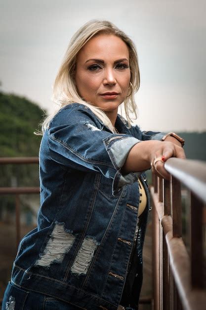 Premium Photo Portrait Of Woman Standing Against Railing