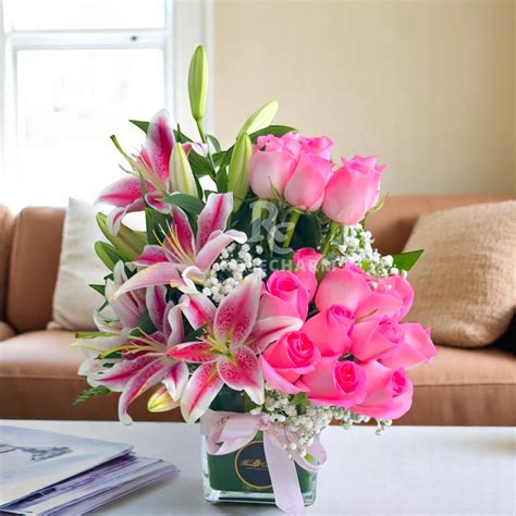 Arrangement Of 15 Pink Rose And 3 Pink Lily With Fillers In A Glass Vase