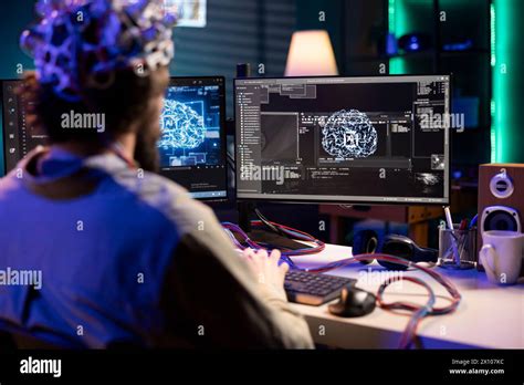 software technician using eeg headset gear translating thoughts into pc