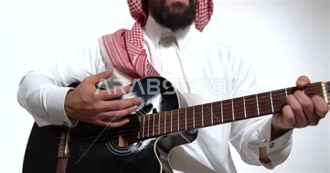 Portrait Of A Young Saudi Arab From The Gulf Playing The Guitar A