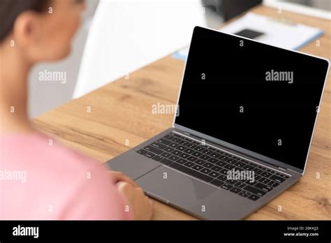 Woman Working On Laptop With Blank Black Screen Stock Photo Alamy