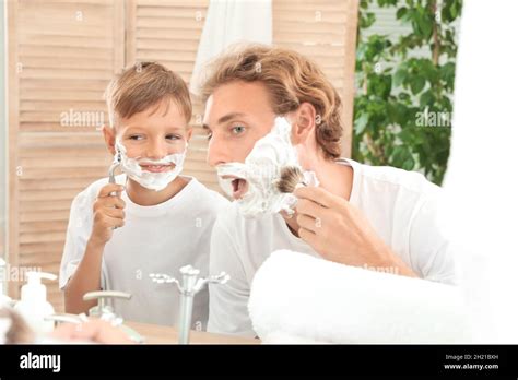Father And Son Shaving Together In Bathroom Stock Photo Alamy