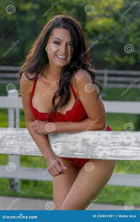 A Lovely Brunette Model Poses In Lingeir Outdoor While Enjoying The