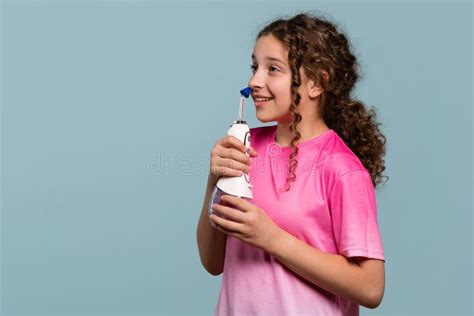 Smiling Young Girl Using An Oral Irrigator Stock Image Image Of Shirt Modern 349333219