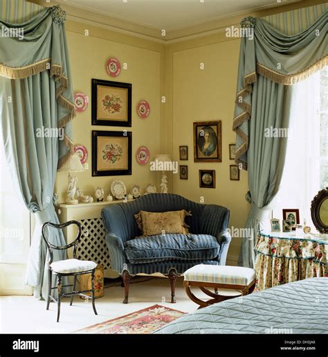 Small Blue Sofa In Corner Of Country Bedroom With Pale Blue Silk