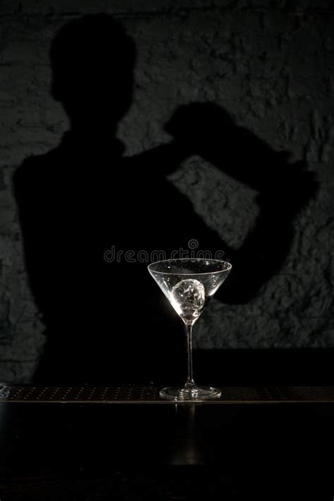 Bartender Shadow Holding A Steel Shaker On The Bar Counter With The Bar