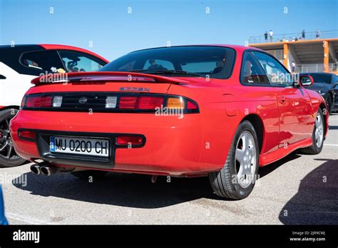 A Rear View Of A Red Classic Japanese Nissan Silvia S14 Kouki Sports