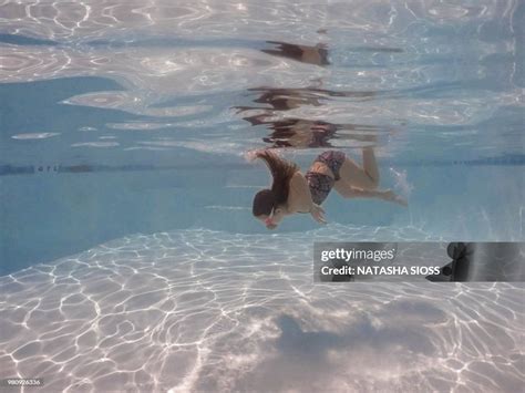 Underwater Photo Of Young Girl In A Swimsuit In A Private Pool High Res