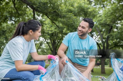 Young Adults Volunteering For Community Clean Up Project In Public Park