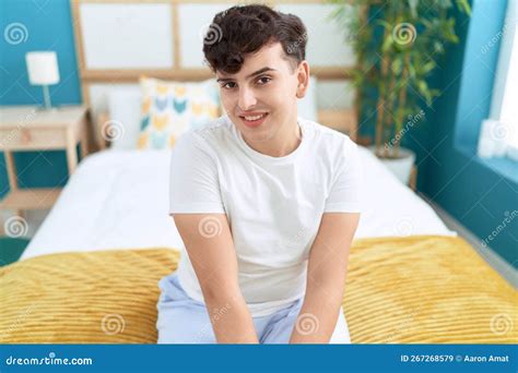 Non Binary Man Smiling Confident Sitting On Bed At Bedroom Stock Image Image Of Positive