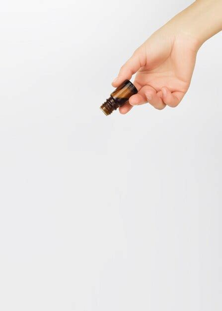 Premium Photo Female Hand Pours Essential Aromatic Oil From A Small