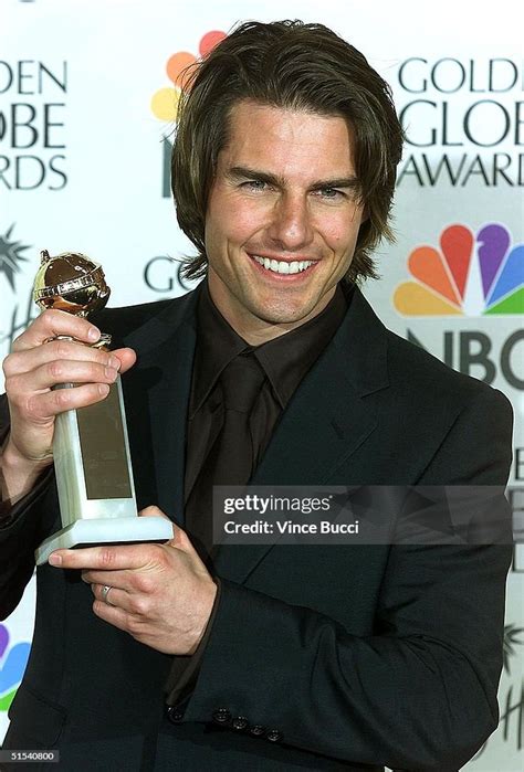 Actor Tom Cruise Holds His Golden Globe Award For Best Performance By