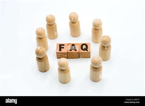 Wooden Figures As Business Team In Circle Around Acronym FAQ Frequently Asked Questions