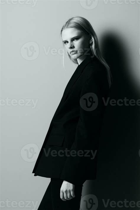 Young Beautiful Stylish Girl Posing Leaning On The Wall In The Studio