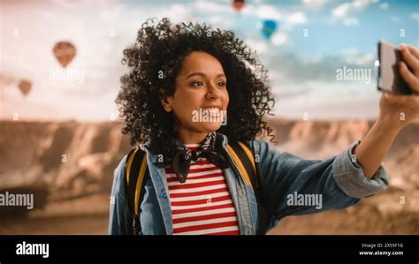 Excited Young Multiethnic Traveller With Afro Hairstyle Making A Selfie