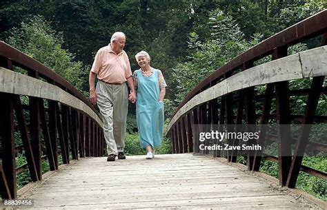 Older Couple Holding Hands On Bridge Photos And Premium High Res