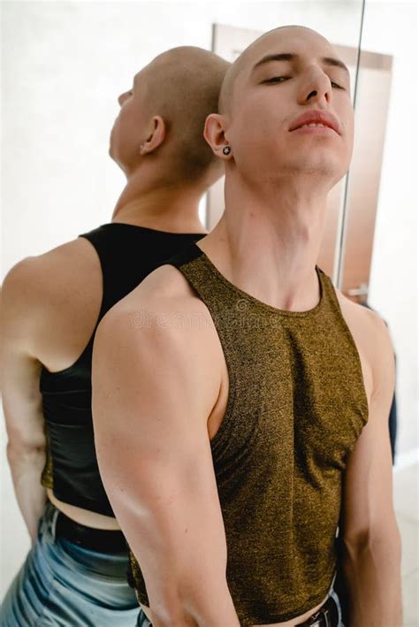 Sensual Caucasian Gay Man In A Tank Top Showing Off His Abs Leaning