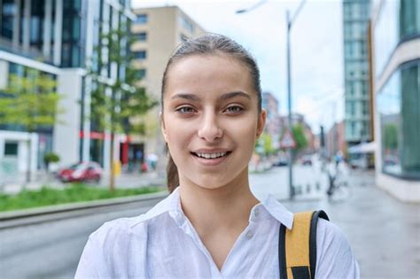 Premium Photo Headshot Portrait Of Teenage Girl Looking At Camera Outdoors On City Street