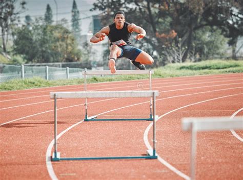 Hurdles Fitness And Athlete Running On Track At Stadium Training For