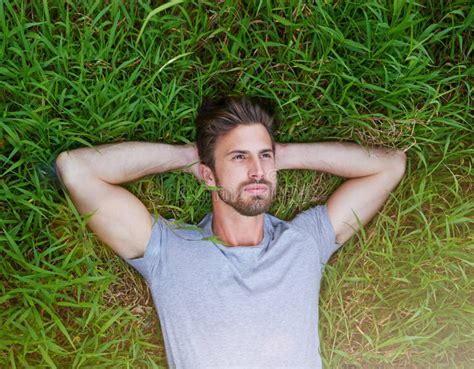 Contemplating Life High Angle Shot Of A Young Man Lying Down On The