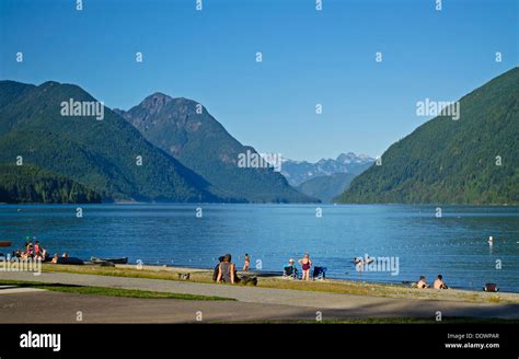 People Enjoying Beautiful Alouette Lake Beach And Mountains In