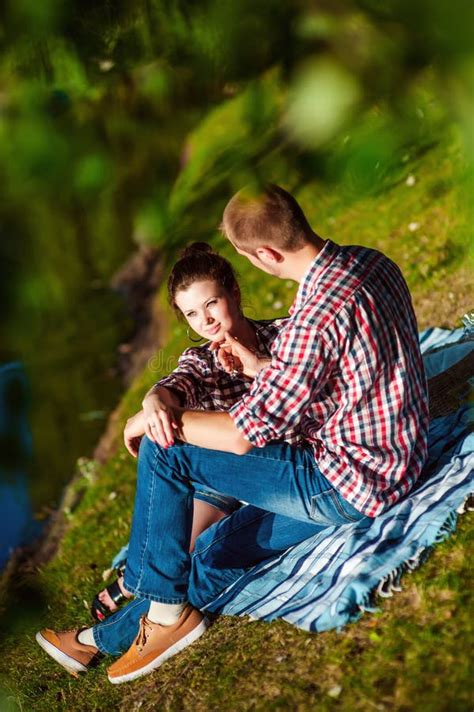 Loving Young Couple Lying In The Grass Stock Image Image Of Jeans