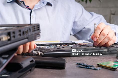 Man Disassembles A Laptop Computer Service And Repair Concept Laptop
