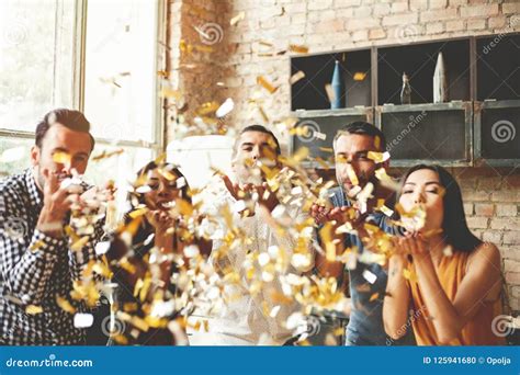 Party Fun Group Of Beautiful Young People Throwing Colorful Confetti