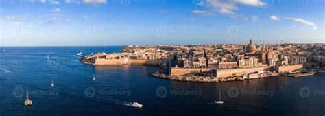 Aerial Panorama Shows Valletta Malta At Sunset Sailboats Crossing