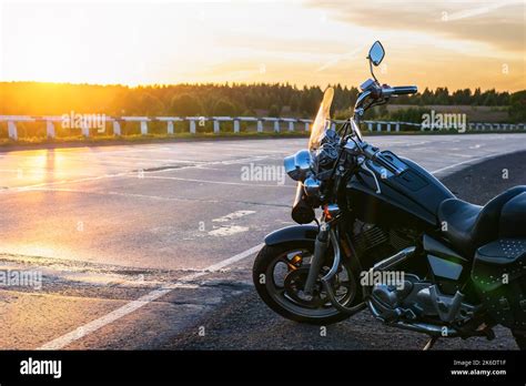 View Of A Cruise Motorcycle Chopper Class Parked By An Asphalt Road