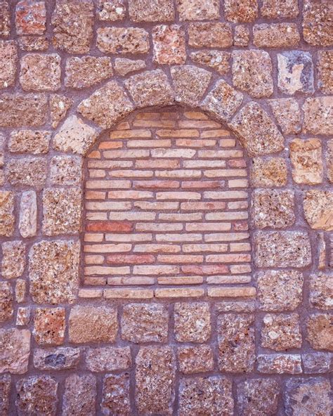 Stonewall With Arch Frame Shape And Brickwork Textured Pattern