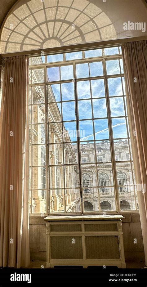 View Through Large Arched Window With Curtains Showing Classical