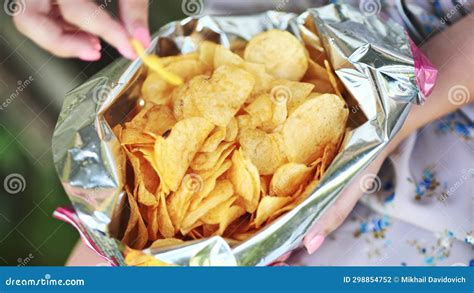 A Girl Eating Chips On A Summer Afternoon A Pack Of Chips In Close Up