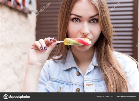 Beautiful Cheerful Sexy Cute Red Haired Girl Eating Colored Ice Cream