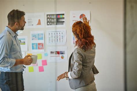 Success Takes Structuring Two Colleagues Having A Brainstorming