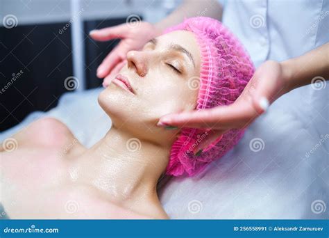 Attractive Female At Spa Health Club Getting A Facial Massage Beautician Doing Massage Of Face
