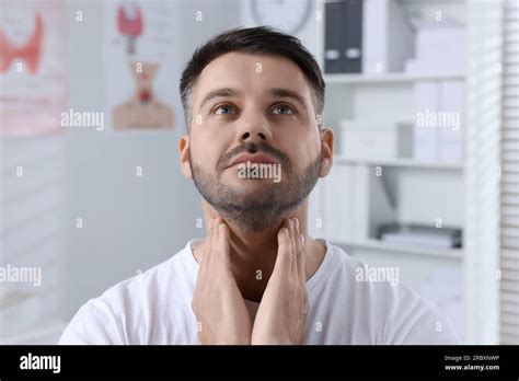 Endocrine System Man Doing Thyroid Self Examination Indoors Stock