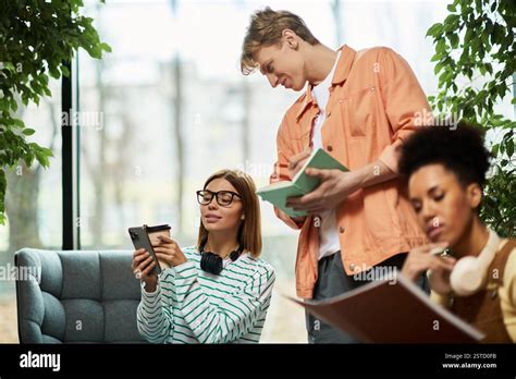 A Group Of Colleagues Engages In Collaborative Tasks In A Hotel Lounge