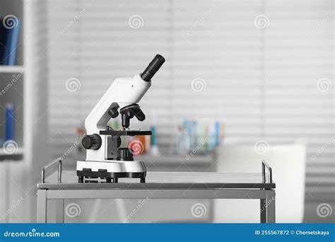 Modern Medical Microscope On Metal Table In Laboratory Space For Text