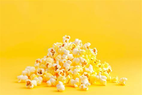 A Heap Of Fluffy Popcorn Kernels Gathered On A Bright Yellow Surface