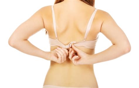 Premium Photo Midsection Of Woman Removing Bra Against White Background
